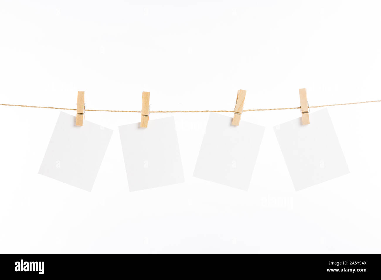 paper cards hanging rope isolated on white background Stock Photo - Alamy