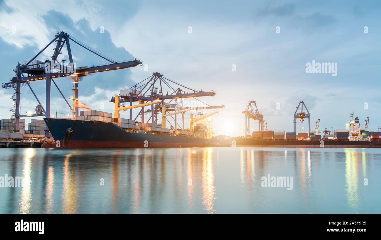 Container ship in the harbor at sunrise Stock Photo - Alamy