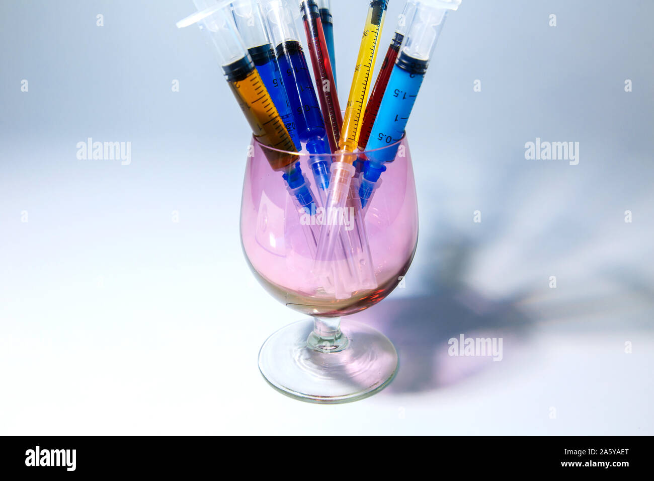 Set of medical syringes in a glass with colored injections for ...