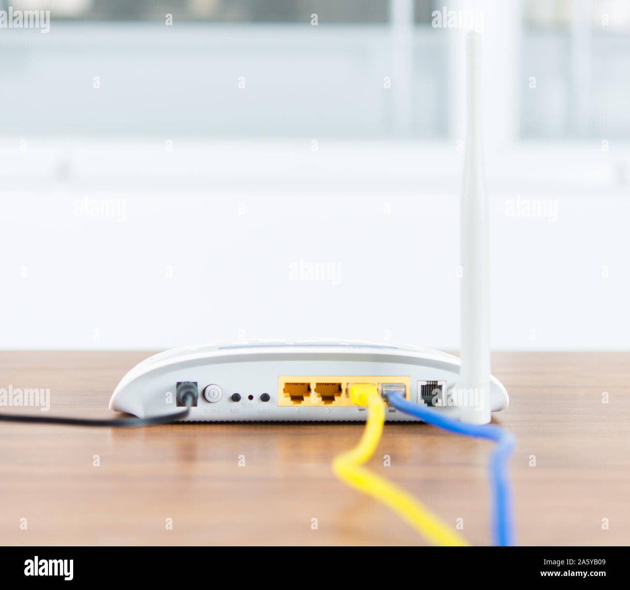 Wireless modem router network hub with cable connect on wooden table in ...