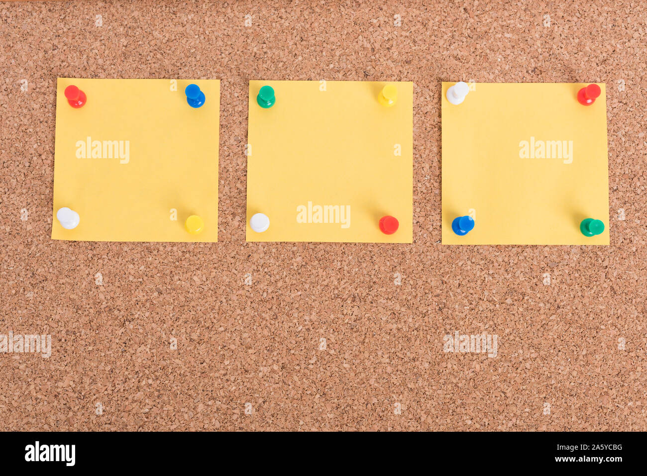 Yellow blank note papers with pin on wooden board background Stock ...