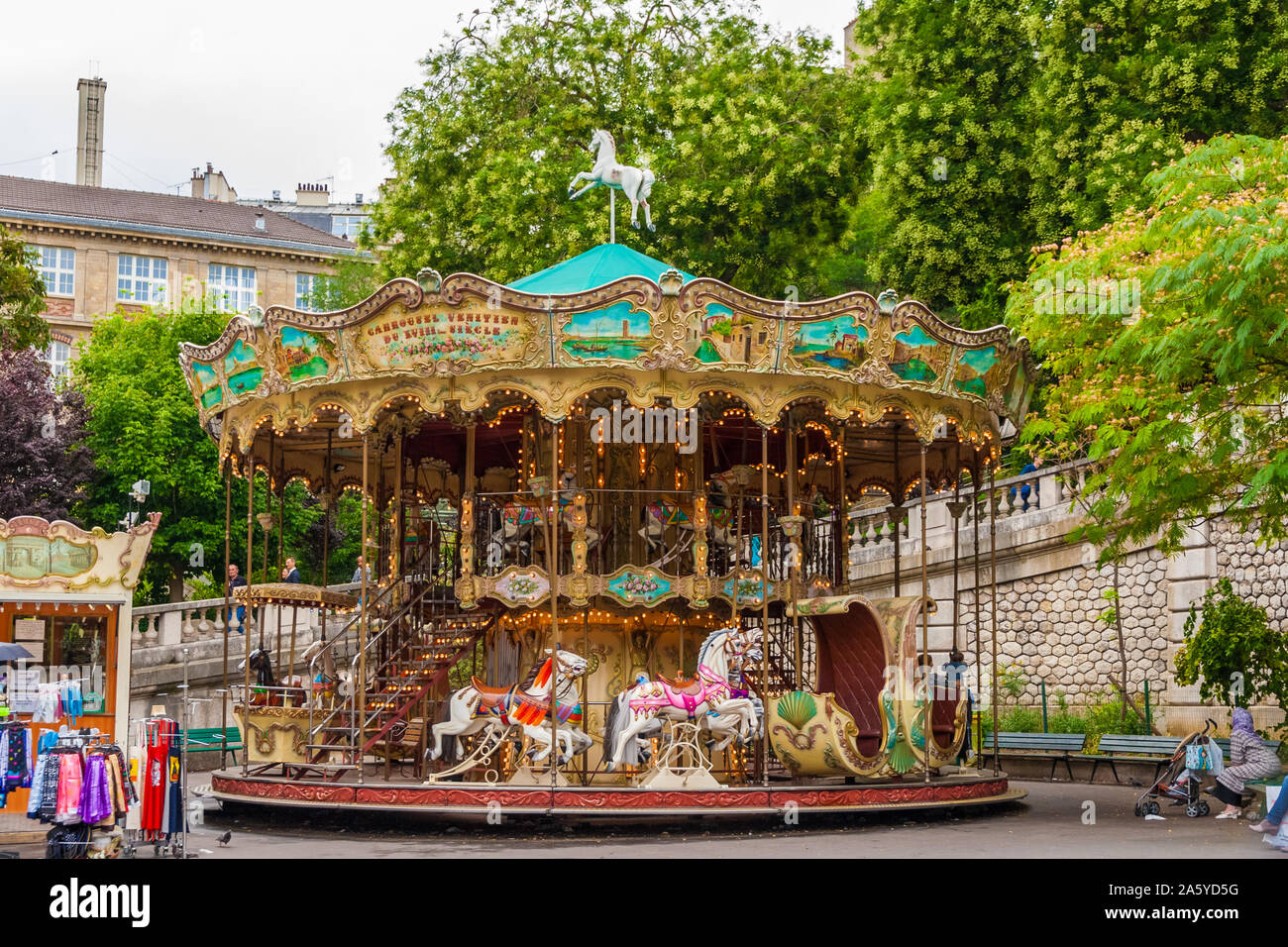 A lovely French old-fashioned style carousel with rows of wooden horses ...