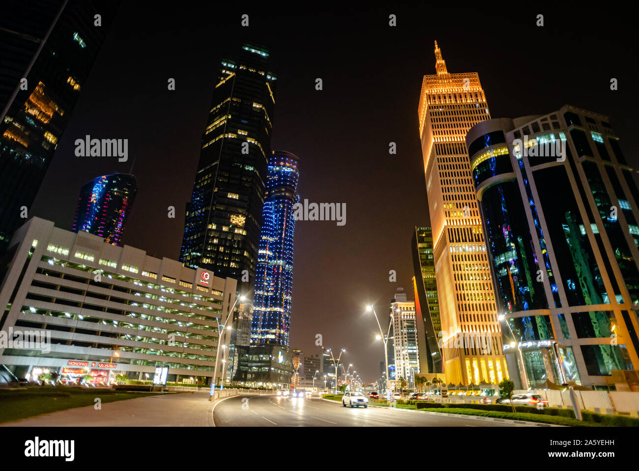A quiet urban street in the financial district of Doha at night. The Al ...