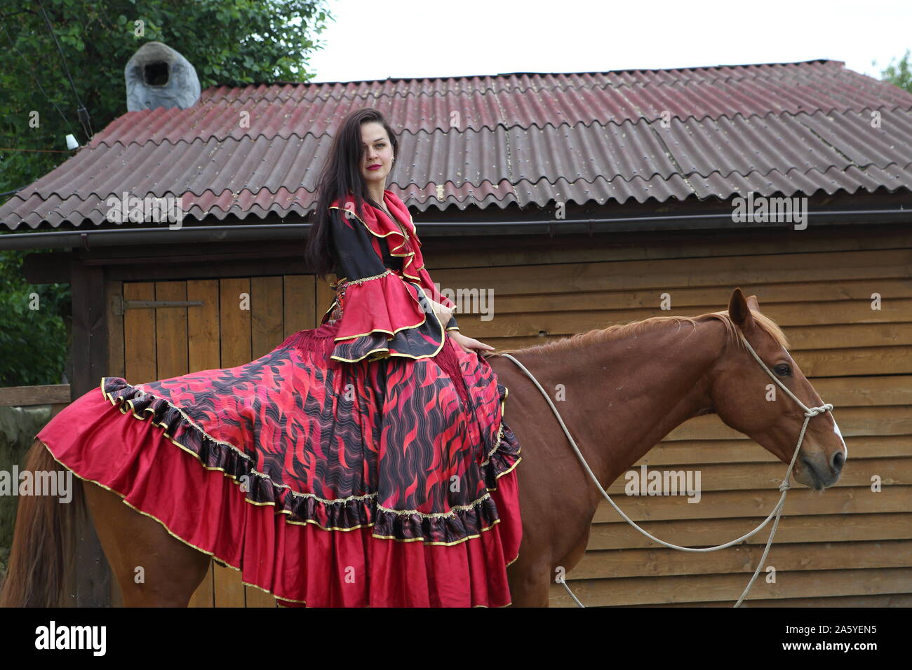 Beautiful young gypsy woman riding a horse Stock Photo - Alamy