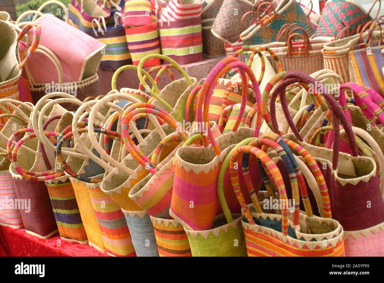 Colorful straw bags on market stall Stock Photo - Alamy