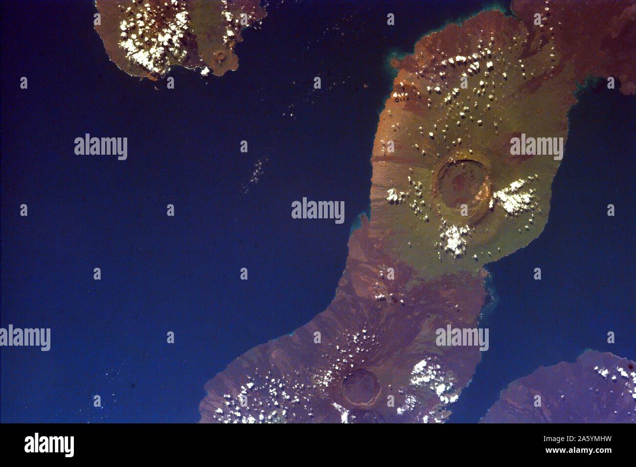This image of the Galapagos Islands captures two large shield volcanoes ...
