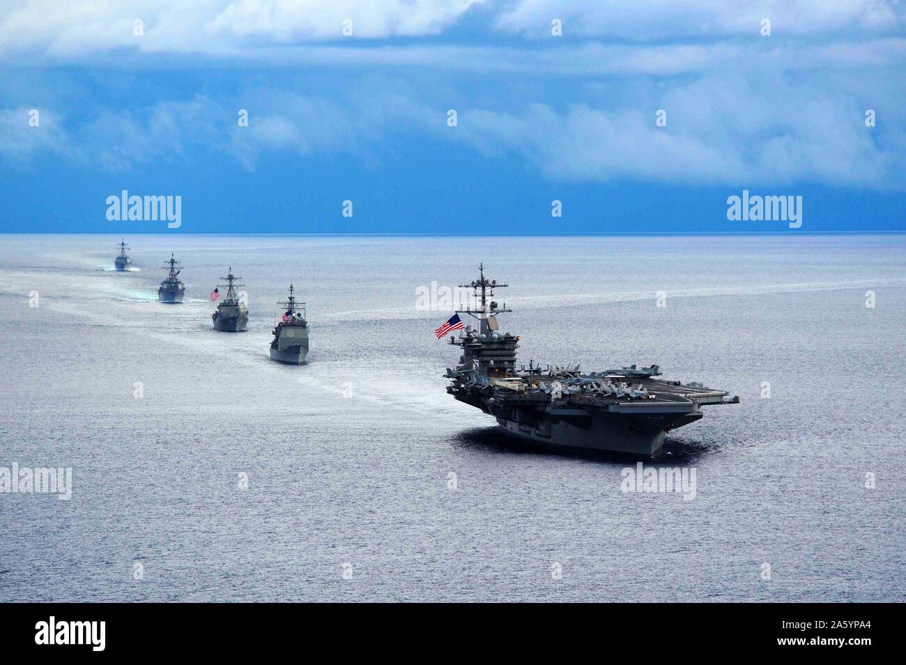 photograph of a the aircraft carrier USS Theodore Roosevelt leading a ...