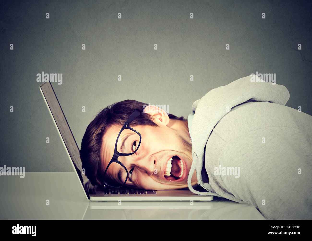 Frustrated young man feeling stressed with his laptop computer Stock ...