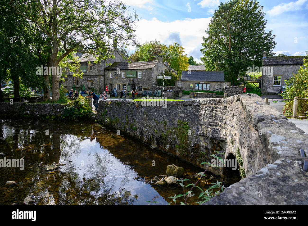 The village of Malham, North Yorkshire with hump backed bridge over the ...