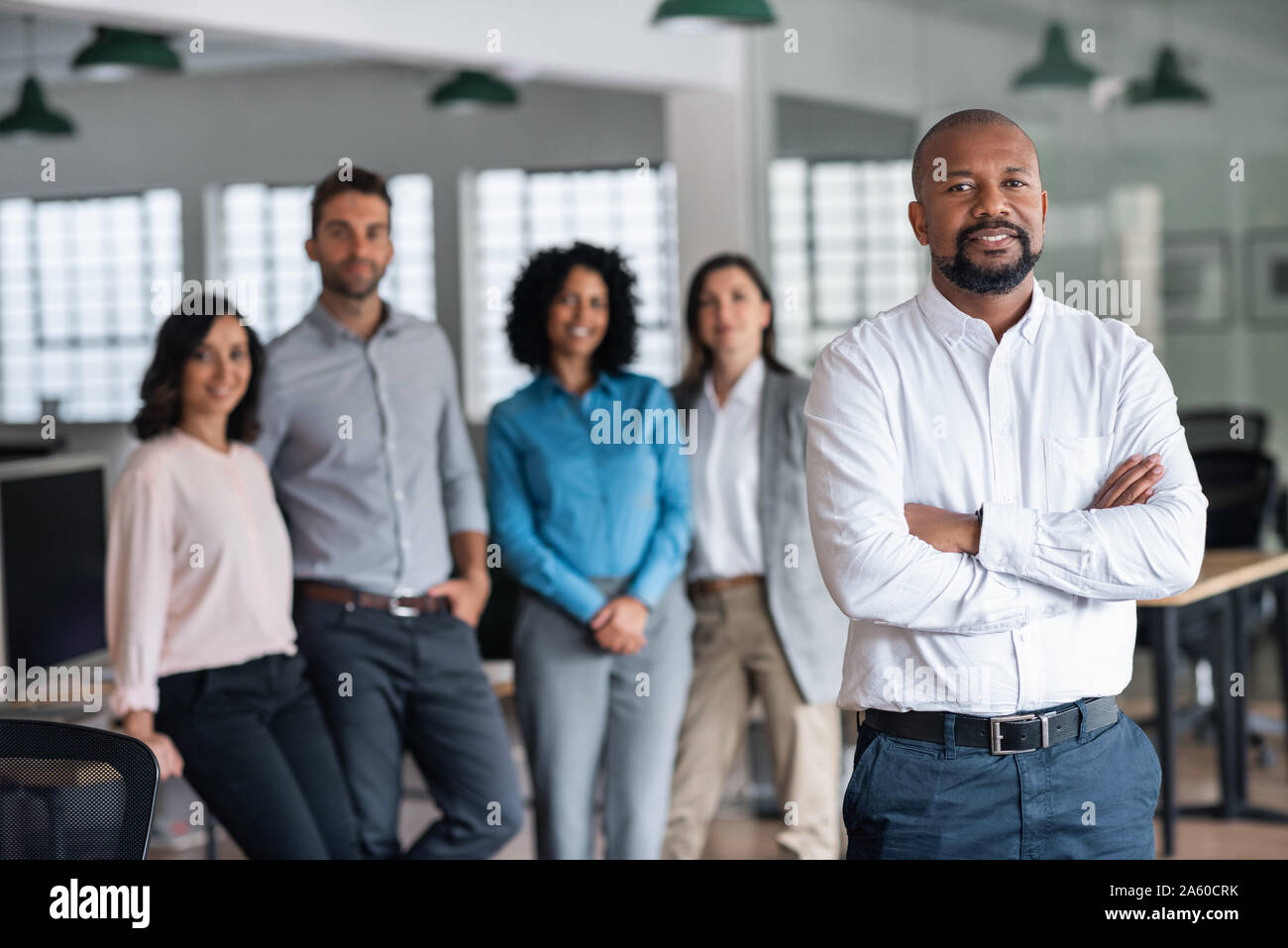 Smiling African American manager and his team in an office Stock Photo ...