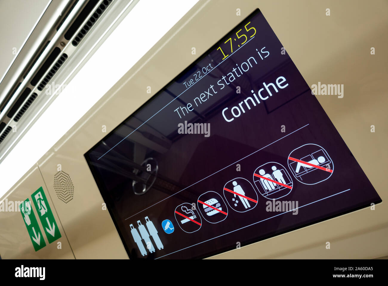 A bilingual digital sign indicating the next metro station is Corniche ...
