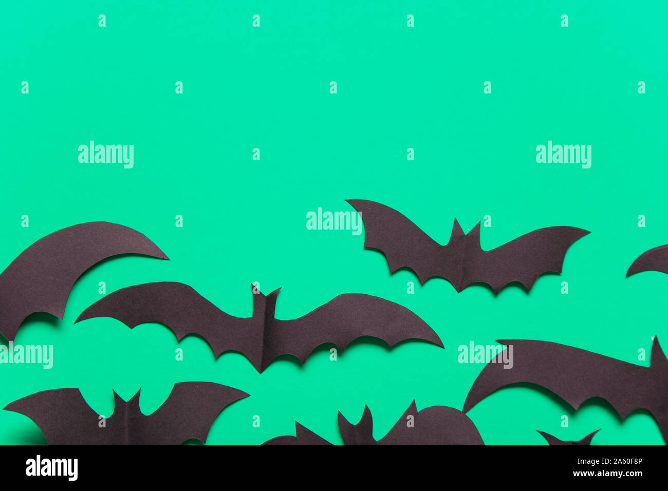 Halloween paper vampire bat decorations on a green background Stock ...