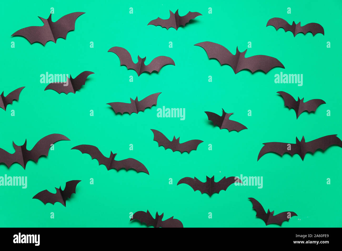 Halloween paper vampire bat decorations on a green background Stock ...