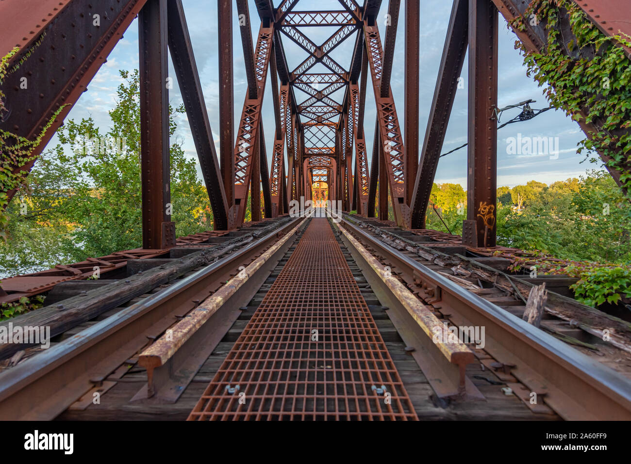 View of the railroad and old steel bridge with green tree Stock Photo ...