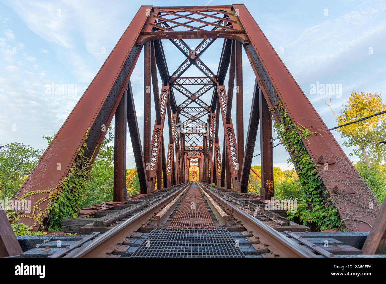 View of the railroad and old steel bridge with green tree Stock Photo ...