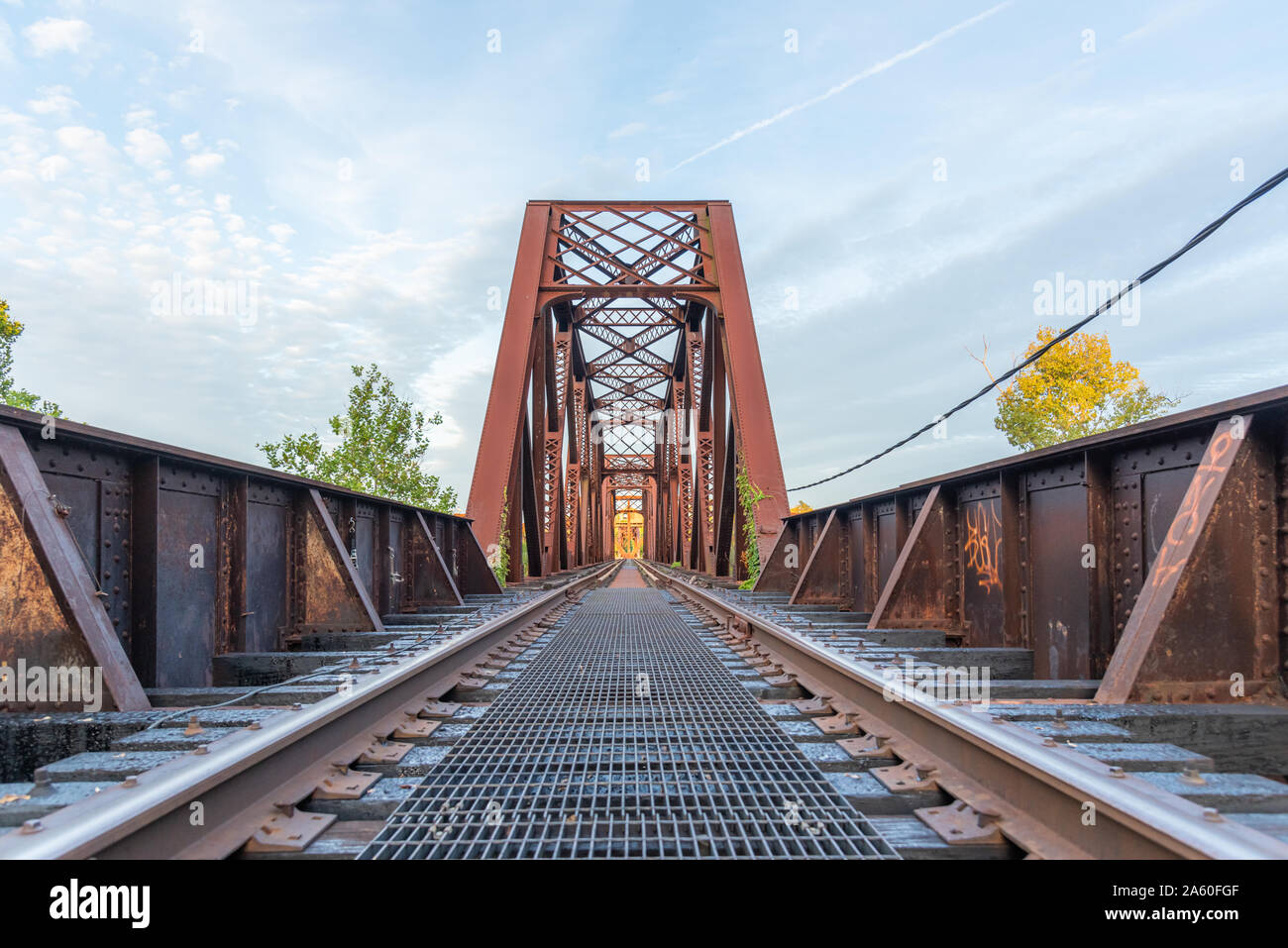 View of the railroad and old steel bridge with green tree Stock Photo ...