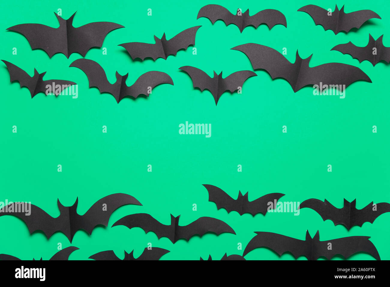 Halloween paper vampire bat decorations on a green background Stock ...