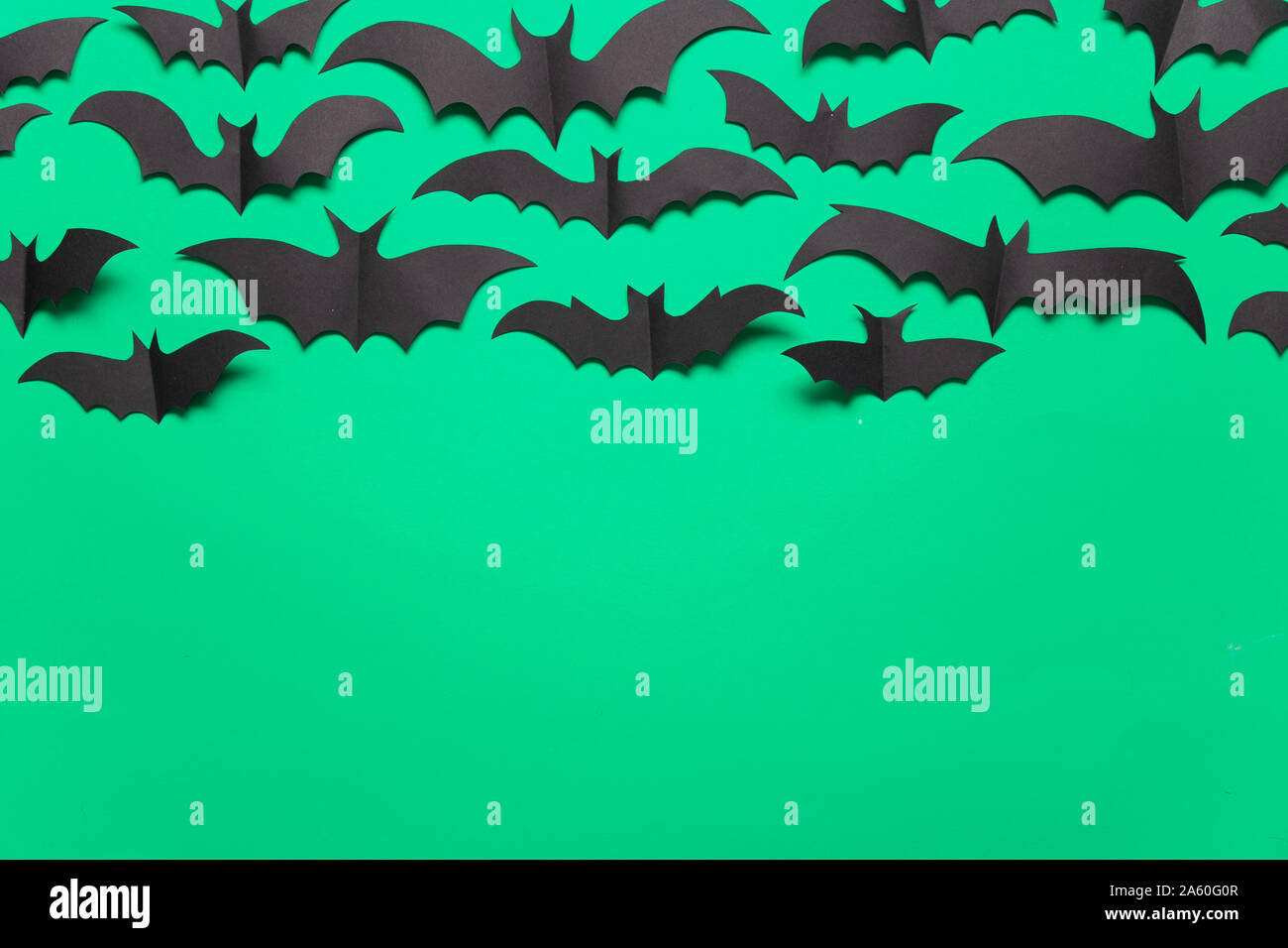 Halloween paper vampire bat decorations on a green background Stock ...