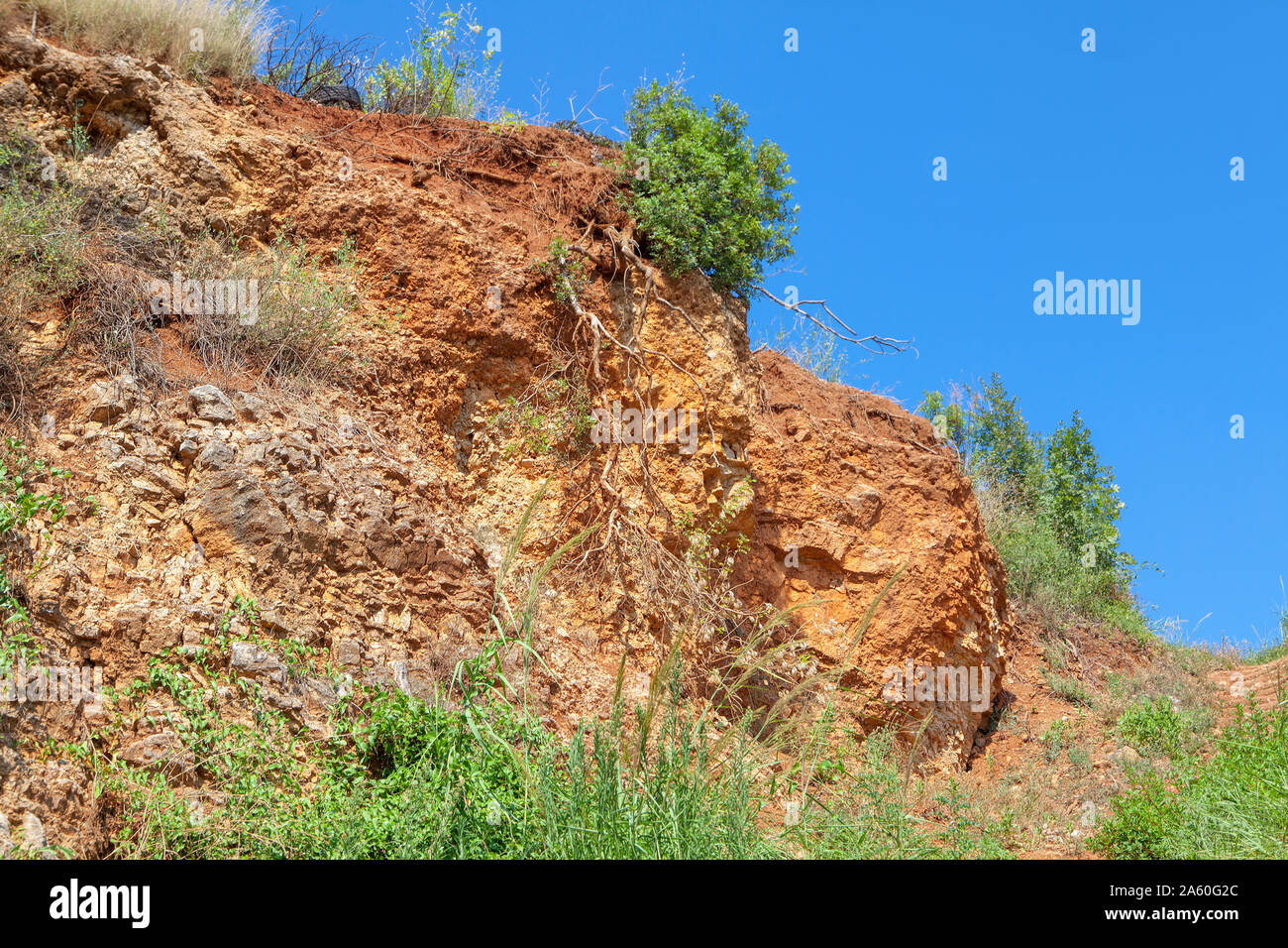 sliding down of clay rock from a mountain Stock Photo - Alamy