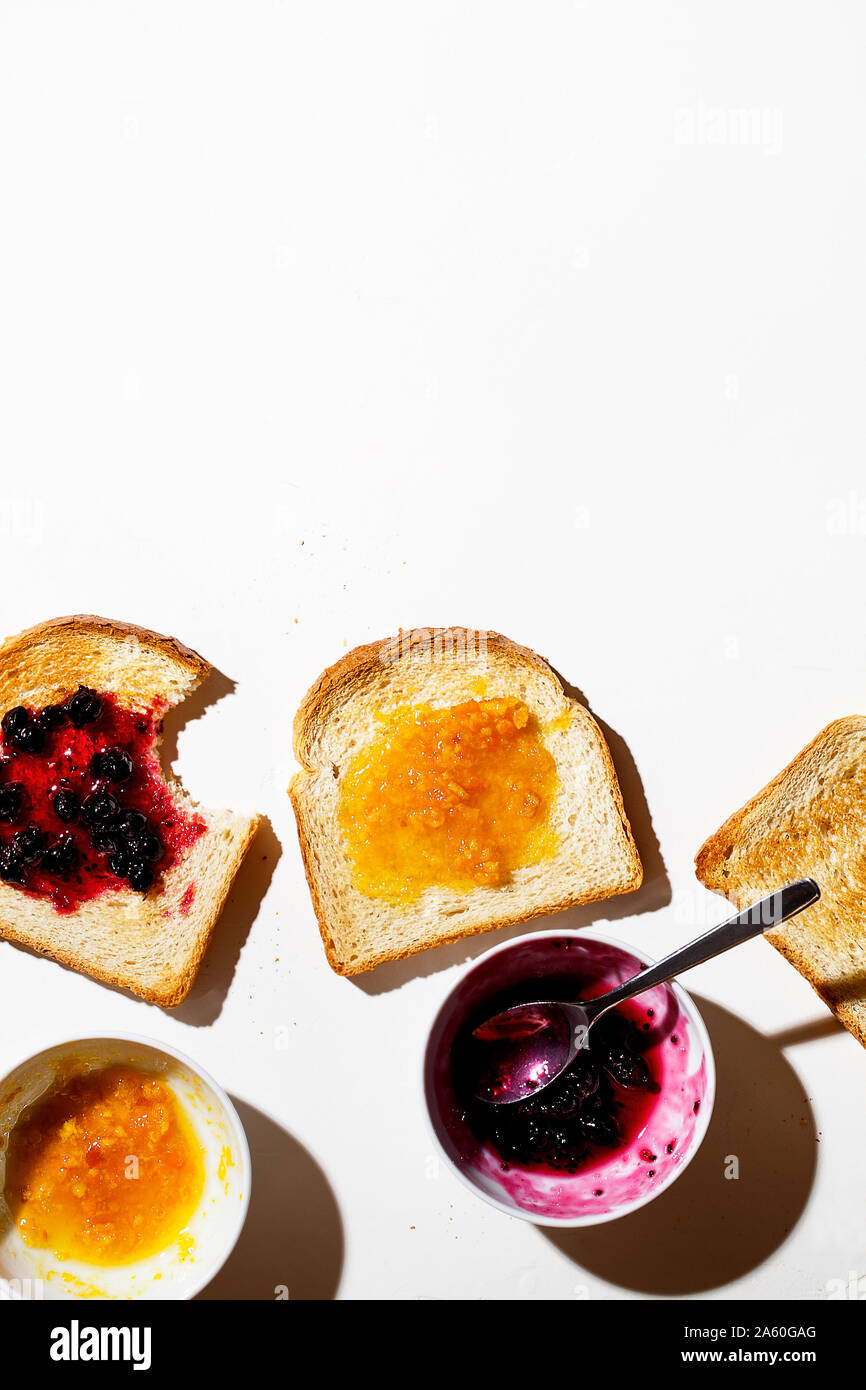 Toasted bread with tasty different jam isolated on a white background ...