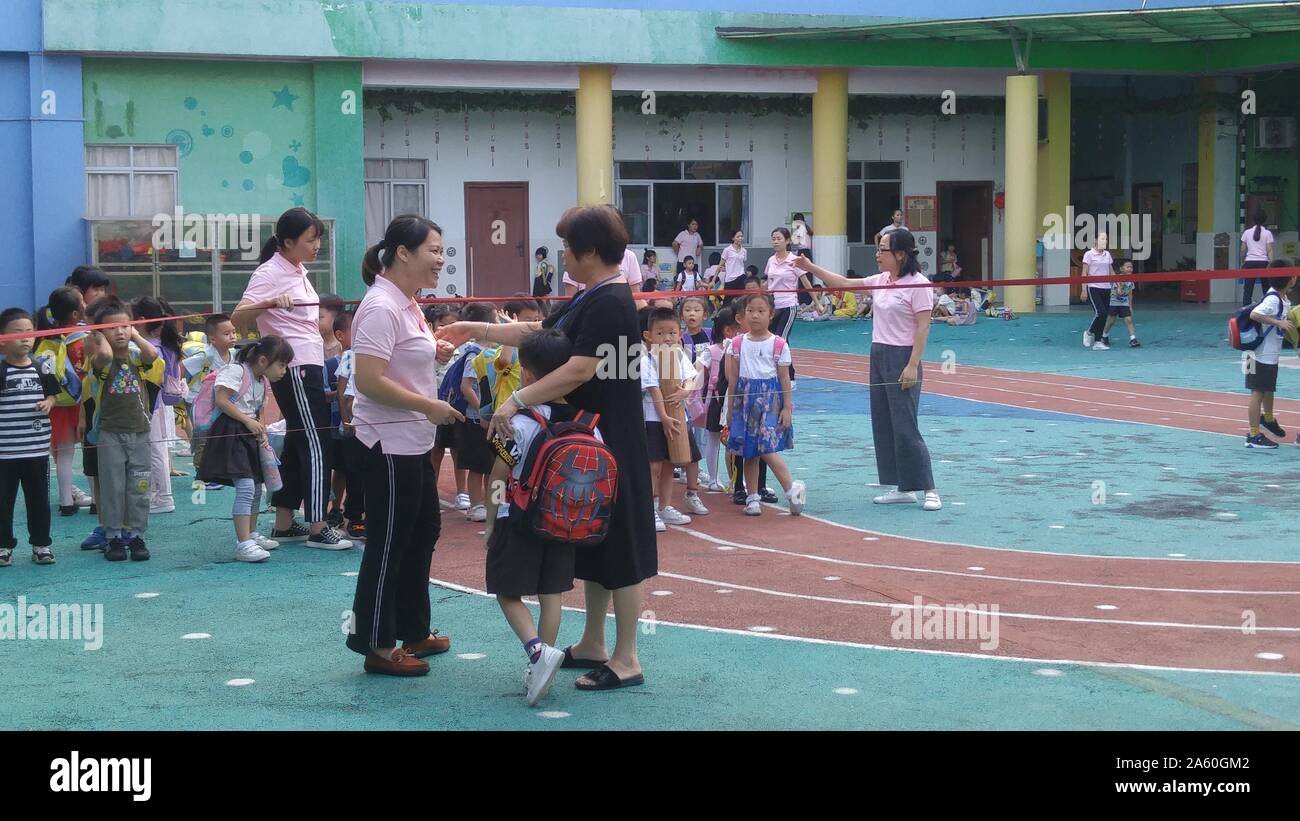 Shenzhen, China: parents pick up their children on the playground after ...
