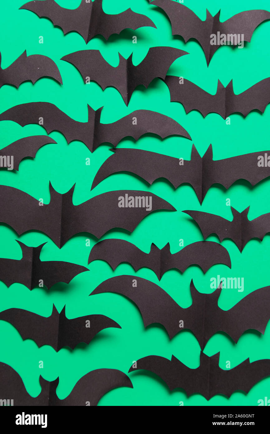 Halloween paper vampire bat decorations on a green background Stock ...