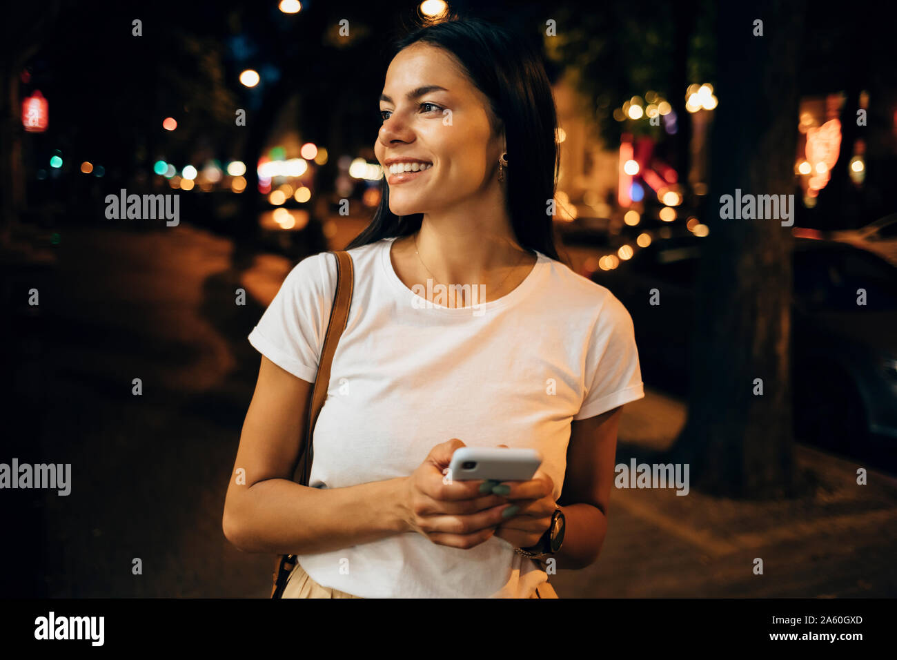 Beautiful young woman using her smartphone lying on her couch in the ...