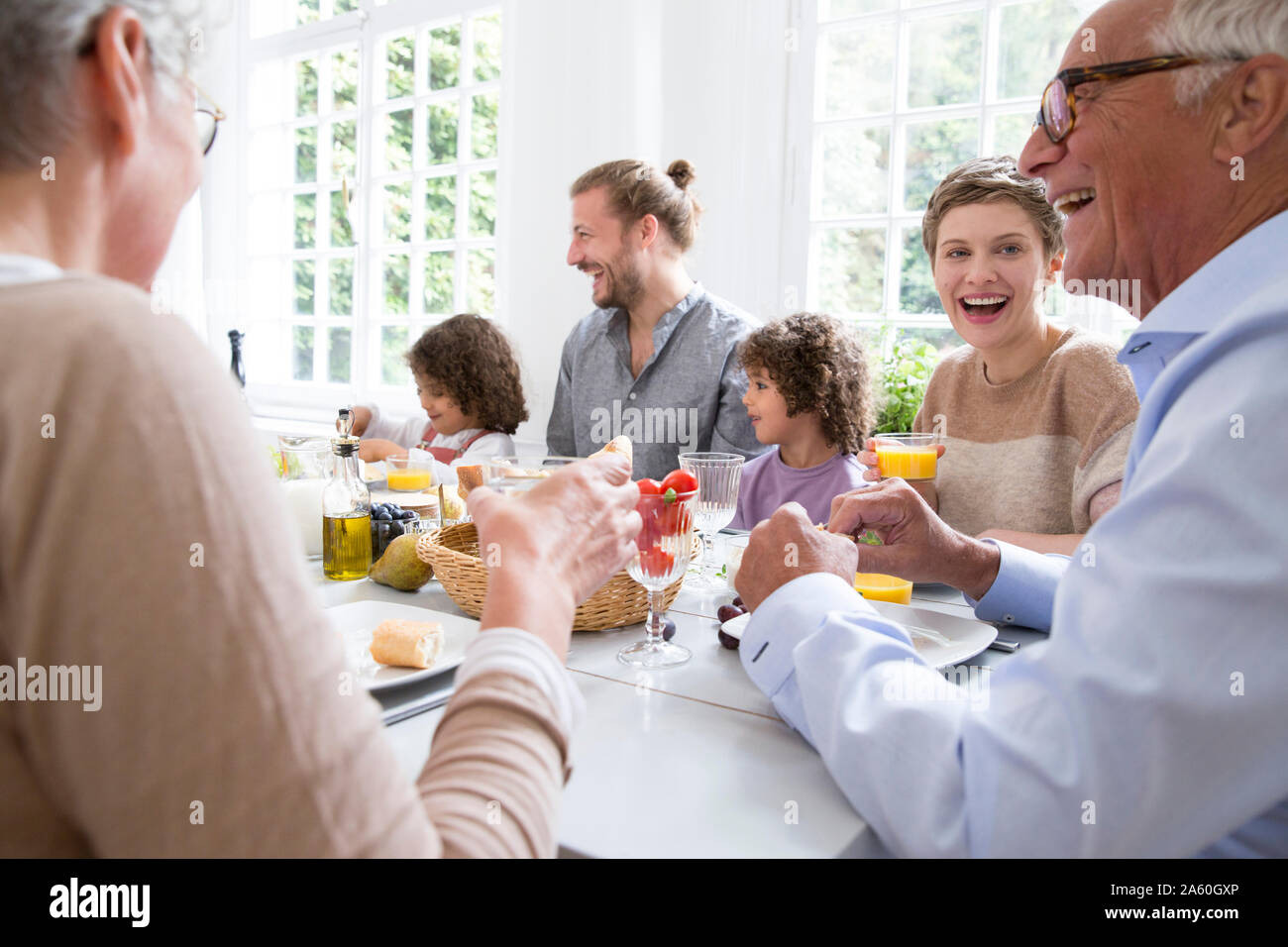 Happy extended family having lunch at home Stock Photo - Alamy