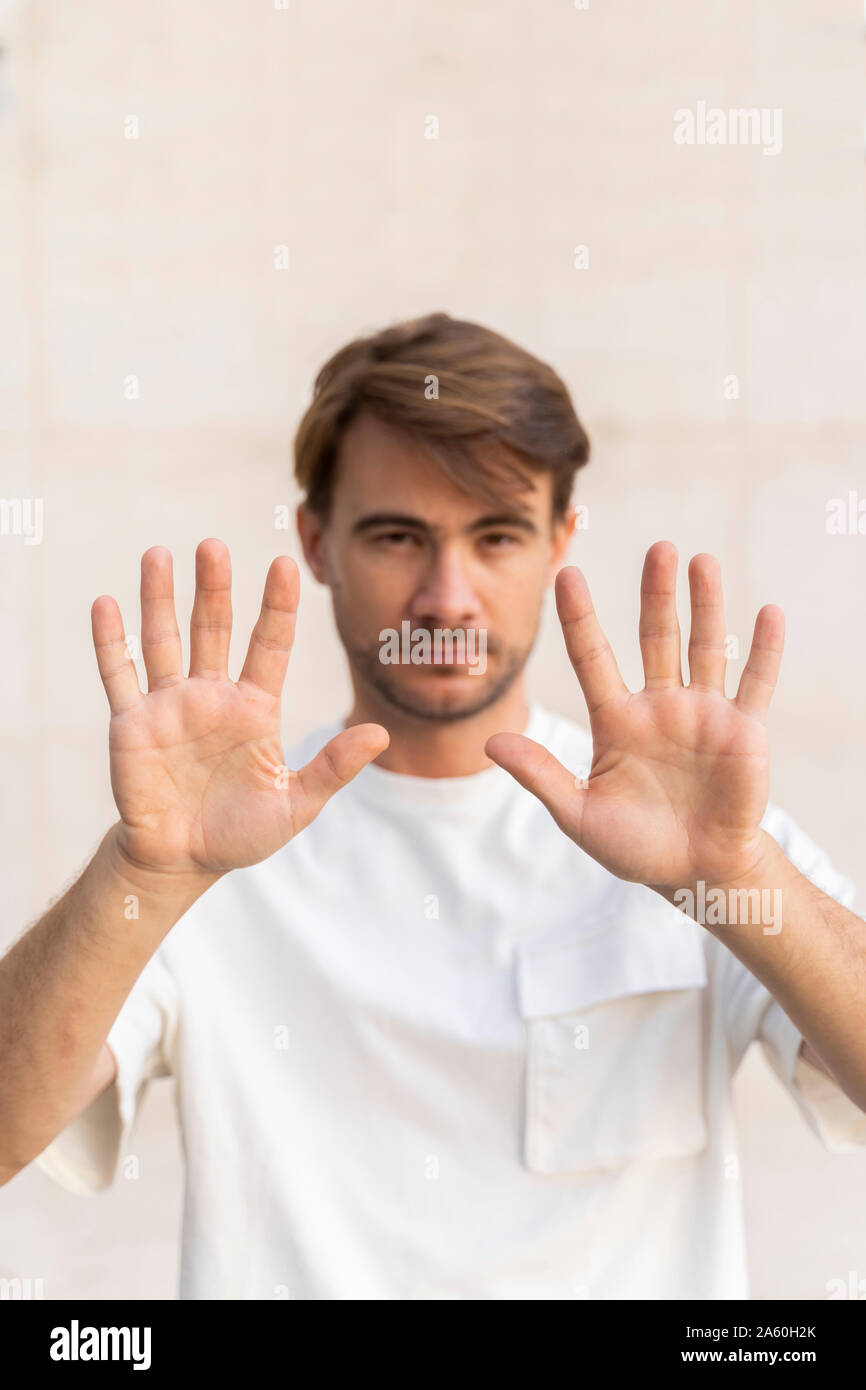 Man raising hands, close-up Stock Photo - Alamy