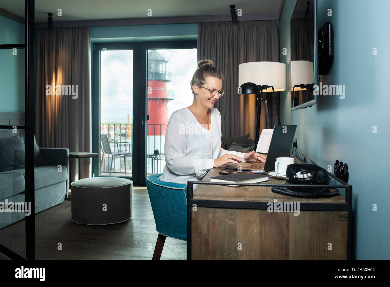Woman working in hotel room Stock Photo - Alamy