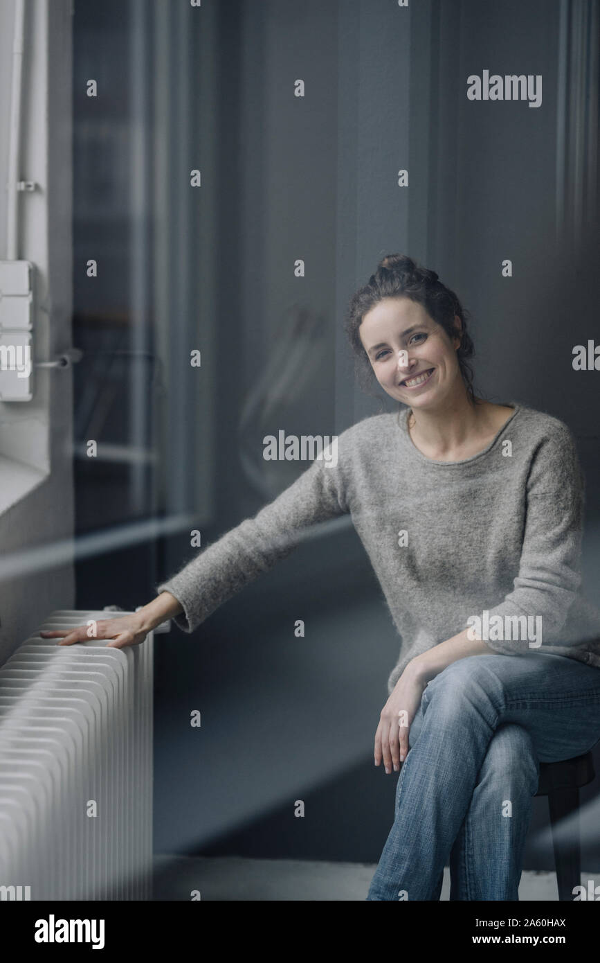 Woman sitting next heating hi-res stock photography and images - Alamy