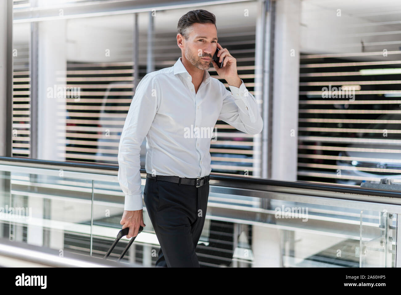 Airport escalator businessman smartphone hi-res stock photography and ...