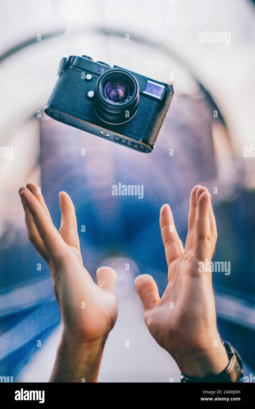Man hands throwing a vintage camera Stock Photo - Alamy