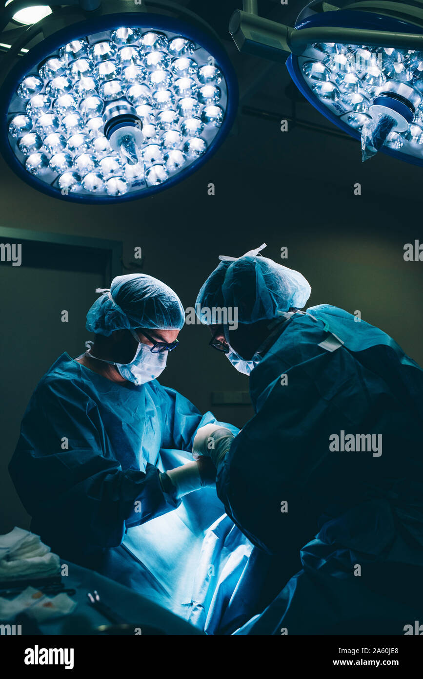 Surgeons during a surgery Stock Photo - Alamy