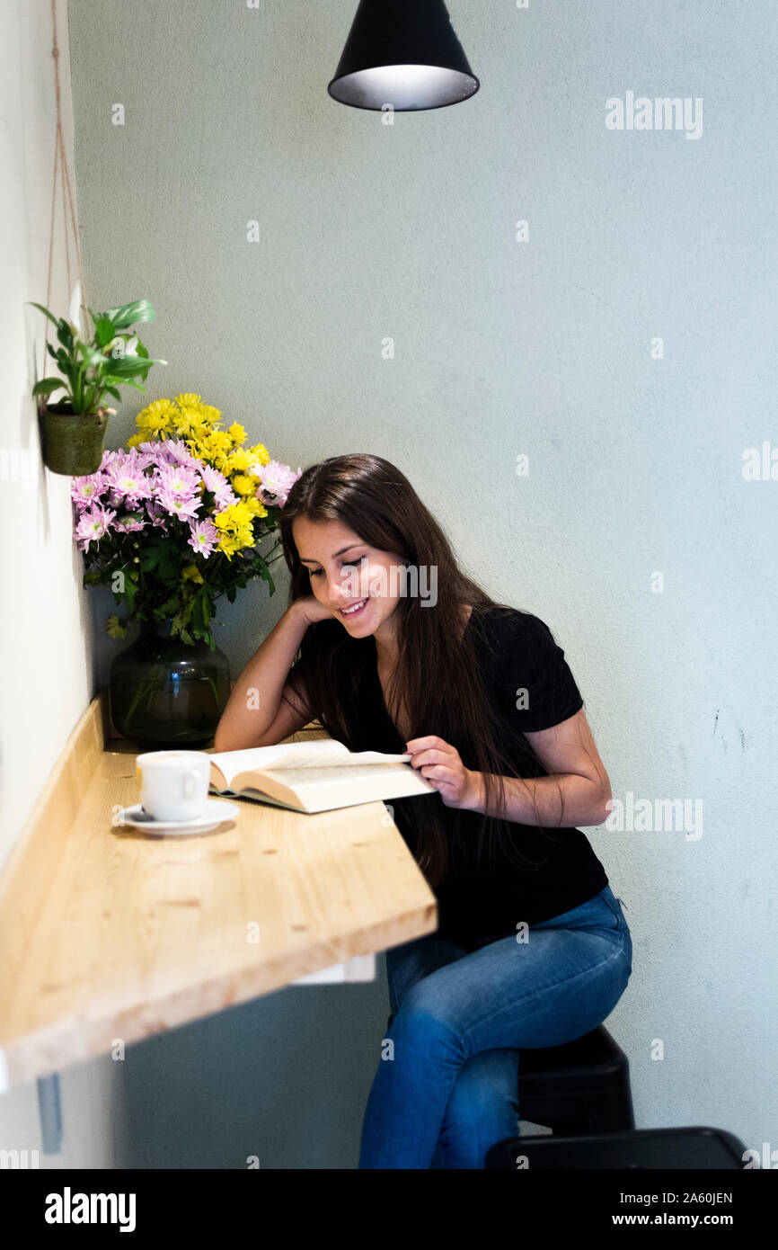 Woman reading a book in a cafe italy hi-res stock photography and ...