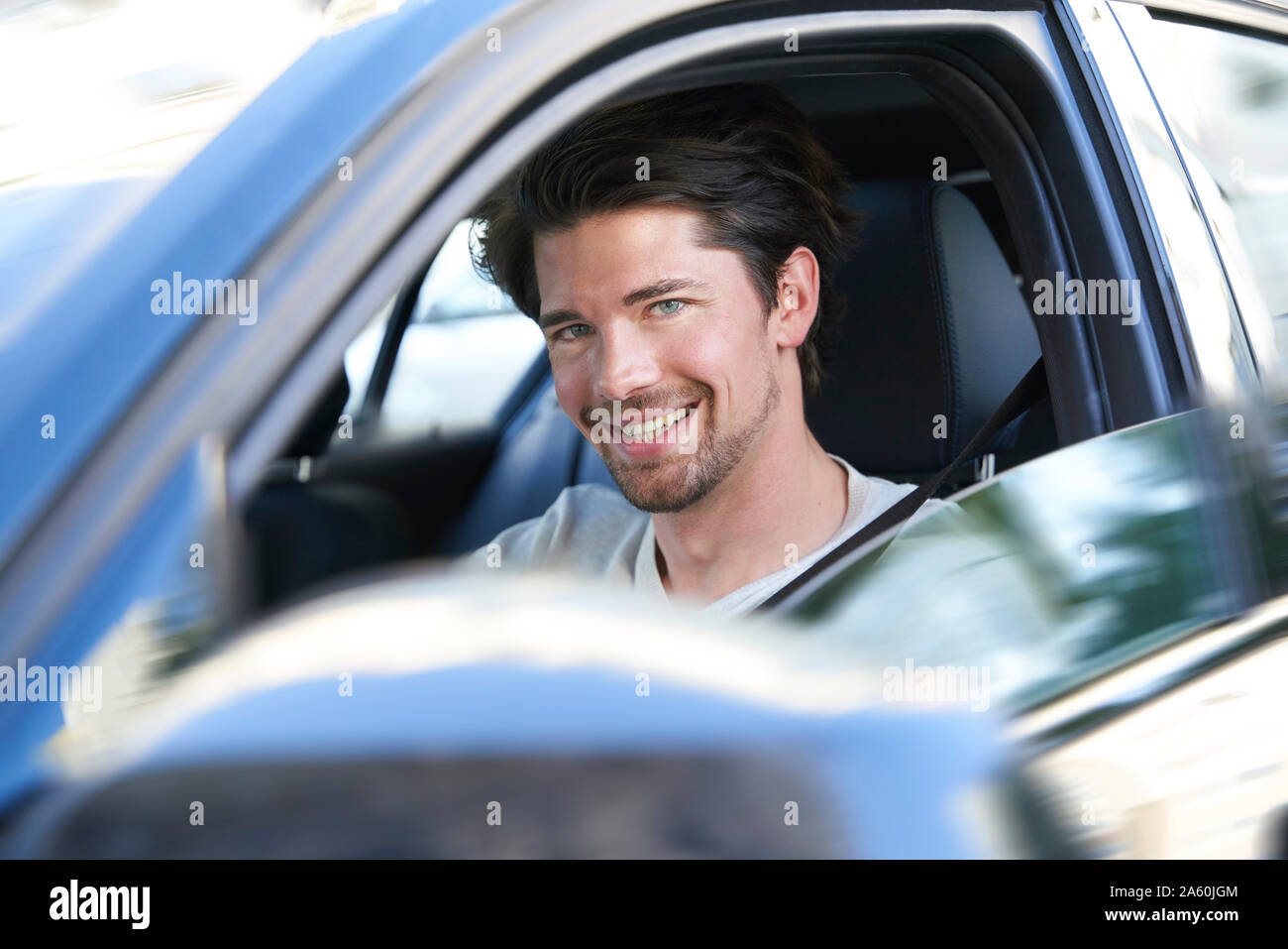 Portrait of smiling man driving car Stock Photo - Alamy