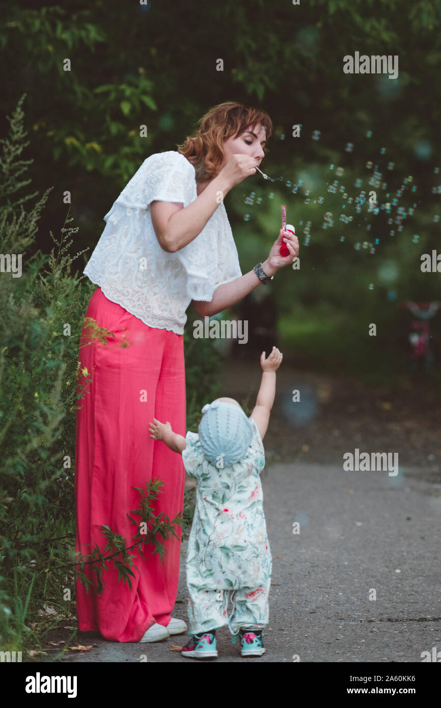 Mother making soap bubbles for her little daughter Stock Photo - Alamy