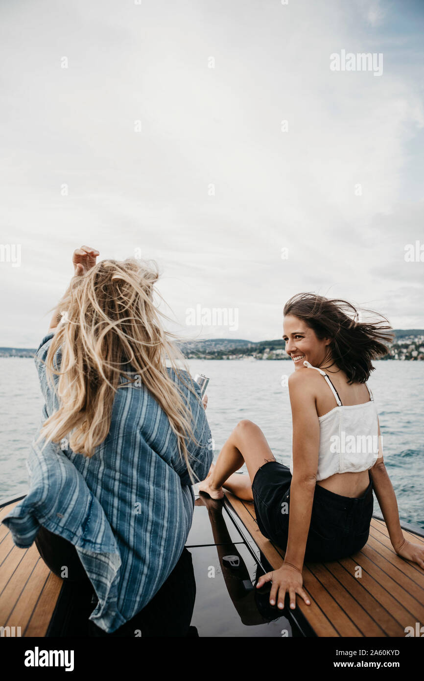 Happy female friends on a boat trip on a lake Stock Photo - Alamy