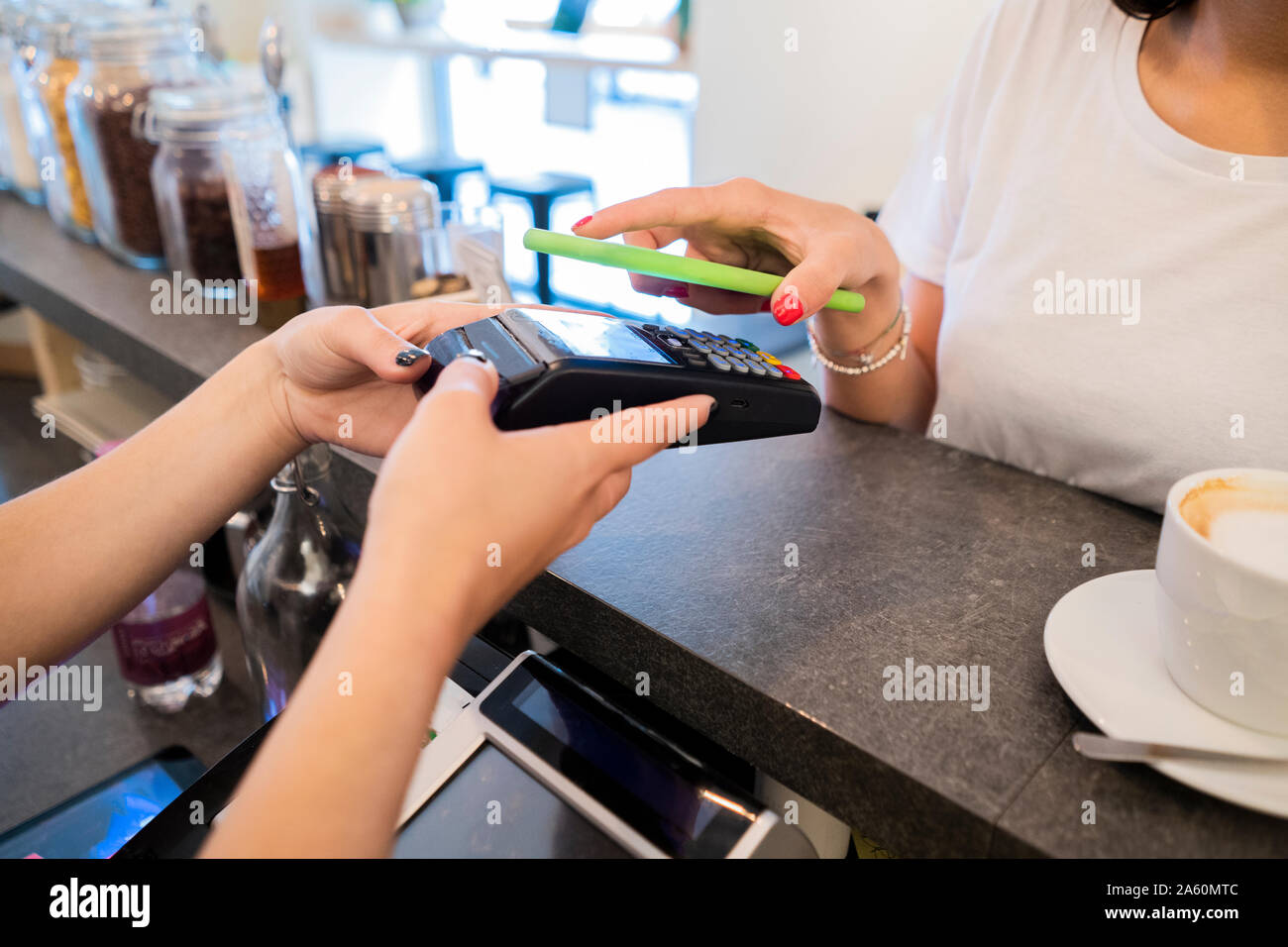 Customer in cafe using smartphone hi-res stock photography and images ...