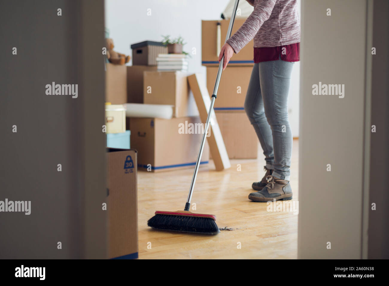 Woman sweeping floor hi-res stock photography and images - Alamy