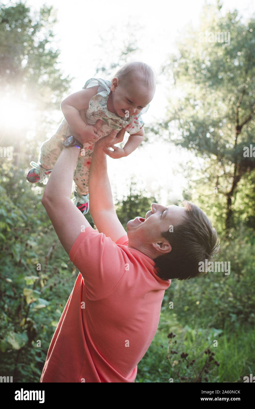 Father lifting up happy daughter Stock Photo - Alamy