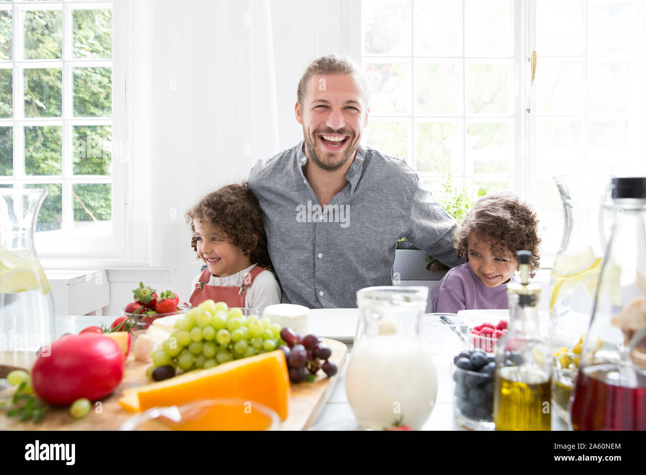 Happy father with two sons having lunch at home Stock Photo - Alamy