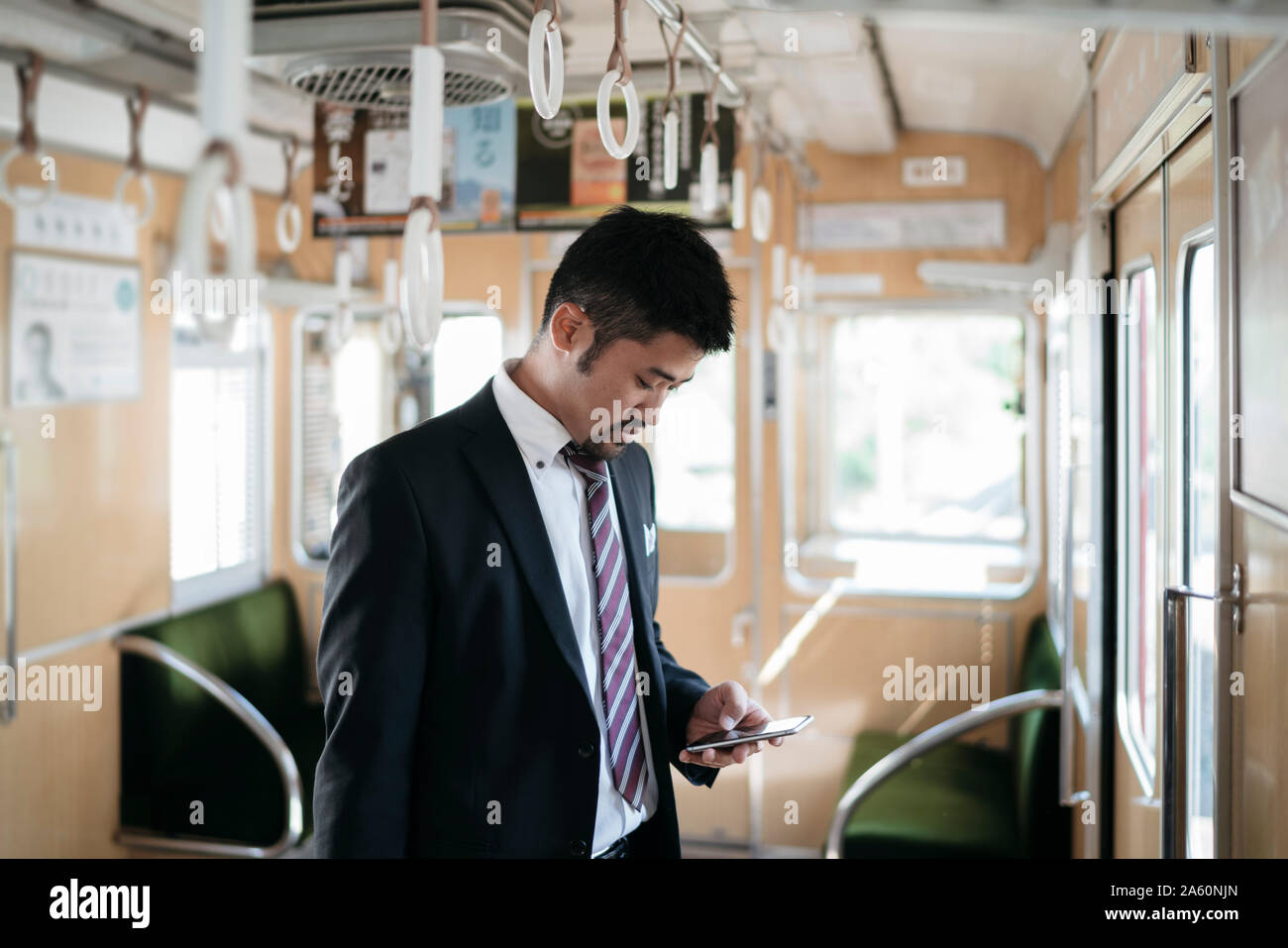 Asian man phone train hi-res stock photography and images - Alamy