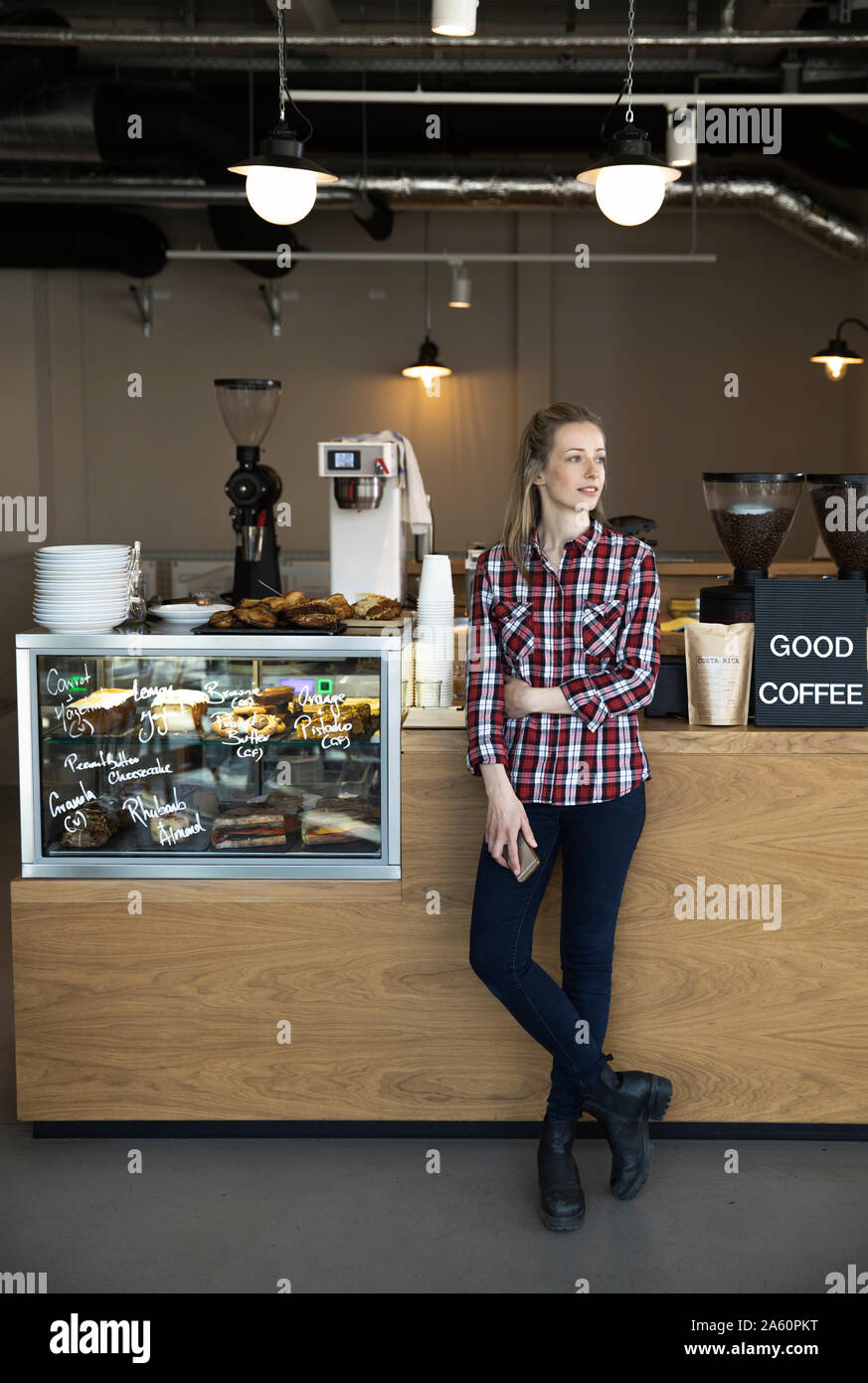 Woman standing café counter hi-res stock photography and images - Alamy