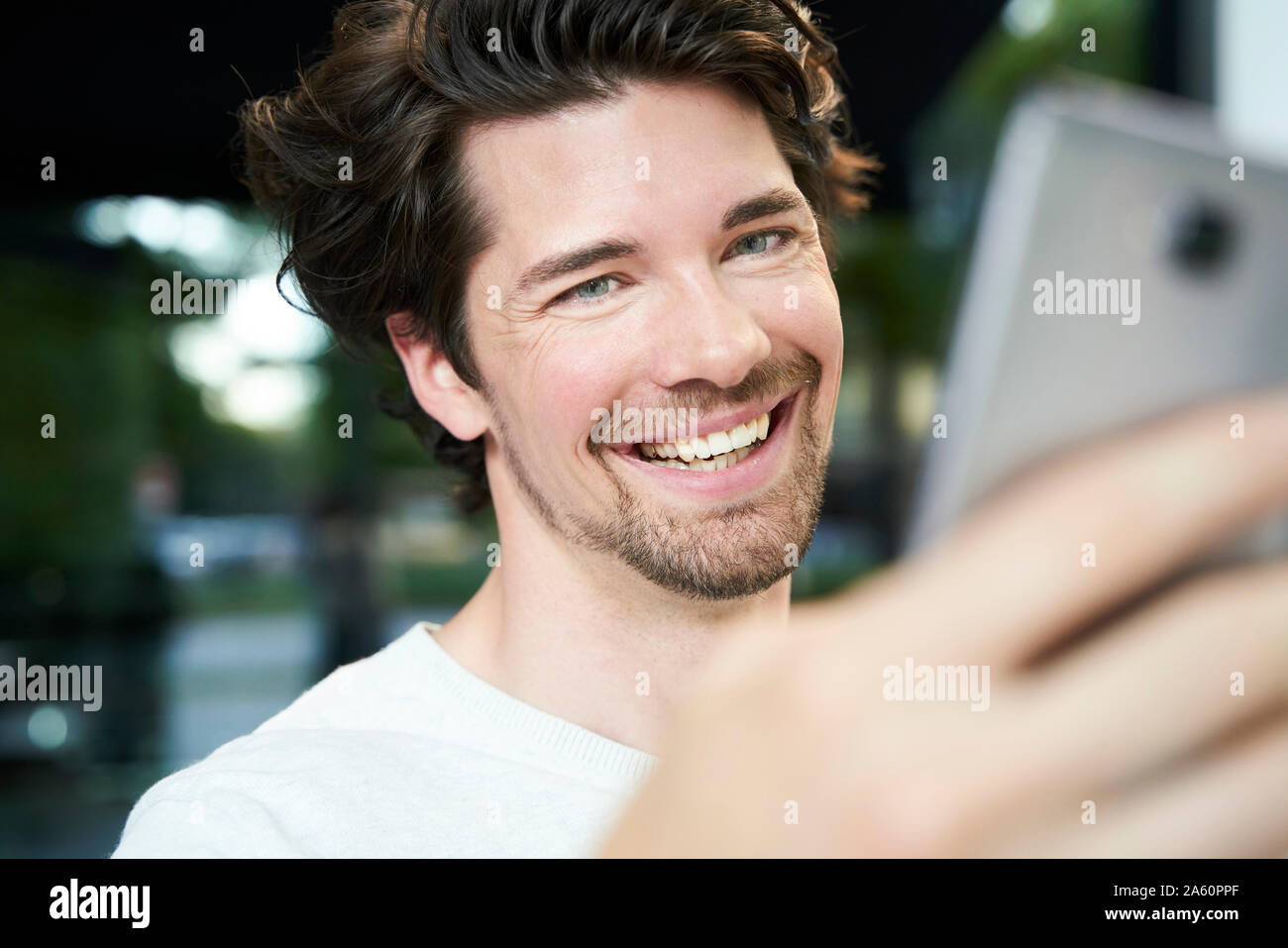 Happy man holding phone hi-res stock photography and images - Alamy