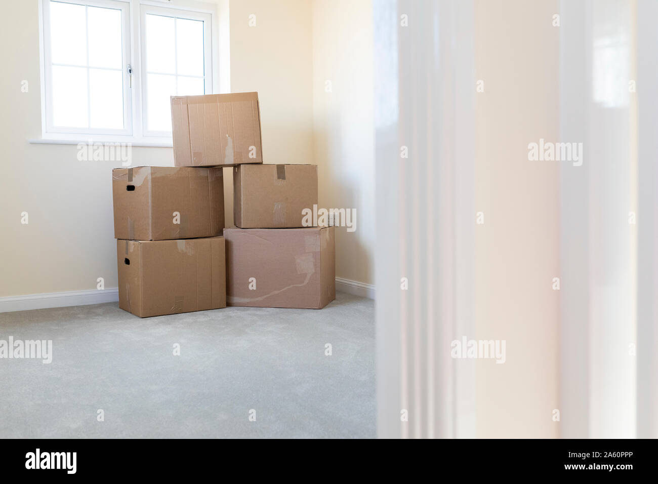Cardboard boxes in an empty room in a new home Stock Photo - Alamy