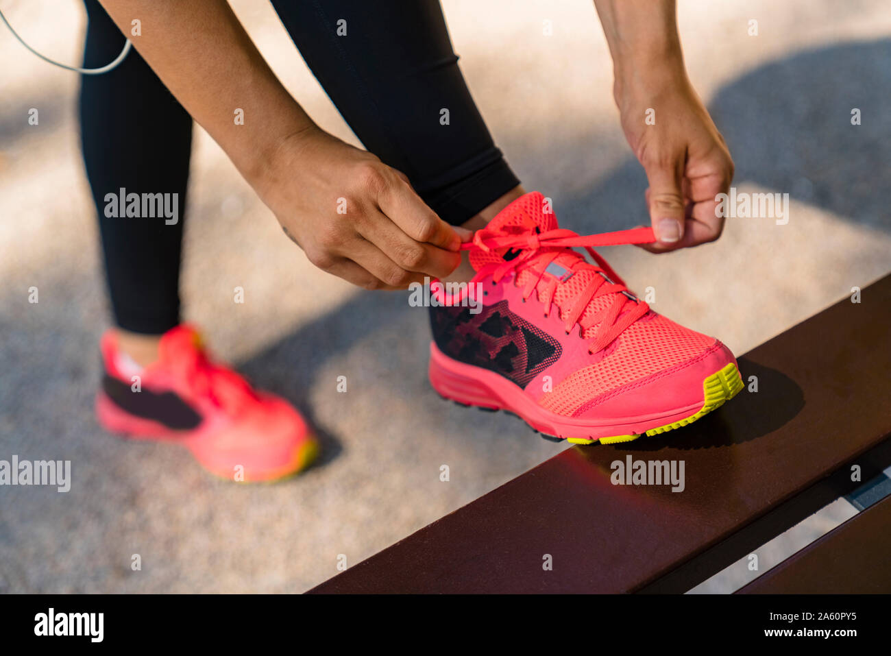 Woman tying her shoes hi-res stock photography and images - Alamy