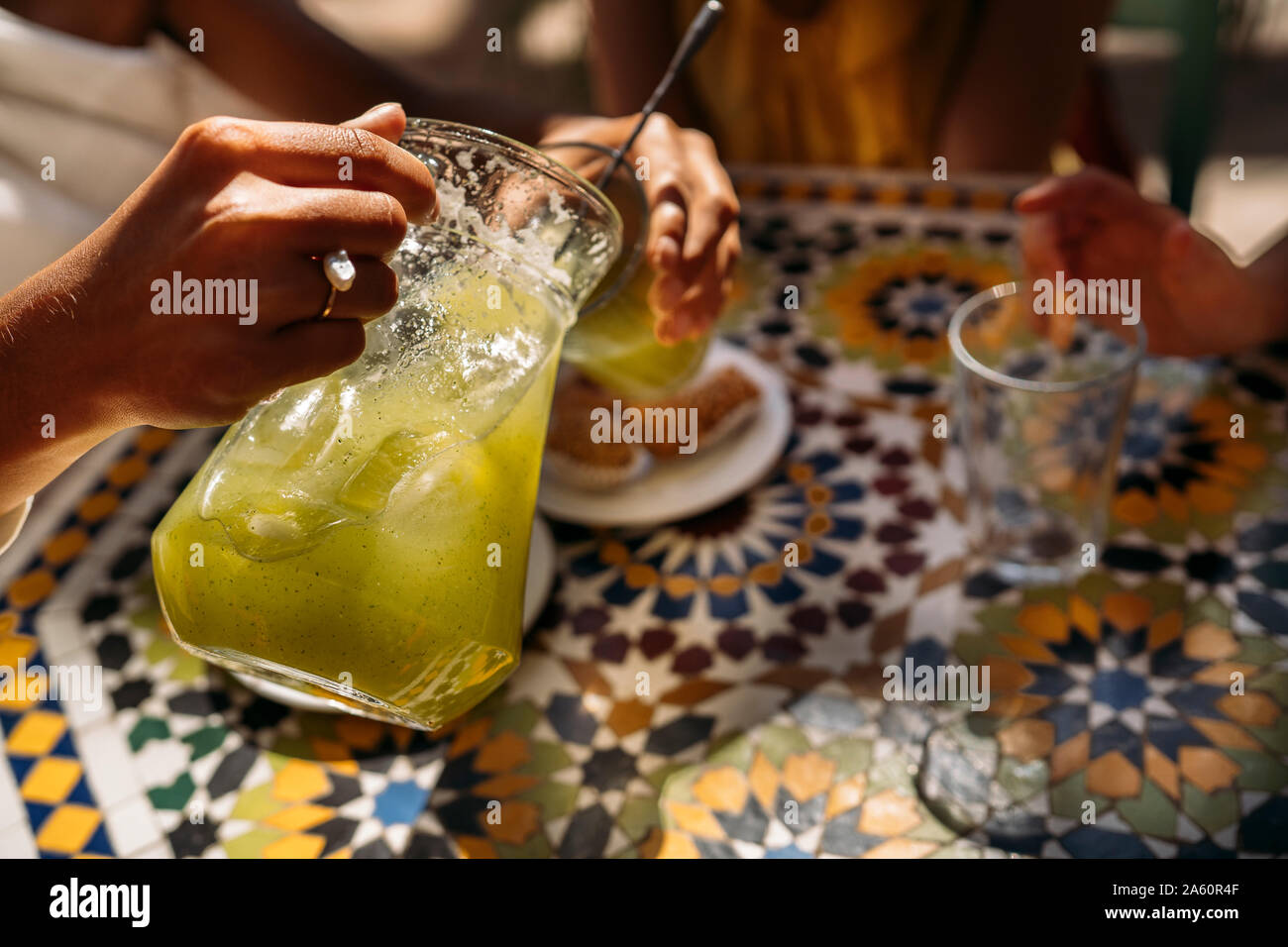 Woman serving lemonade to her friends in a Moroccan cafe Stock Photo ...