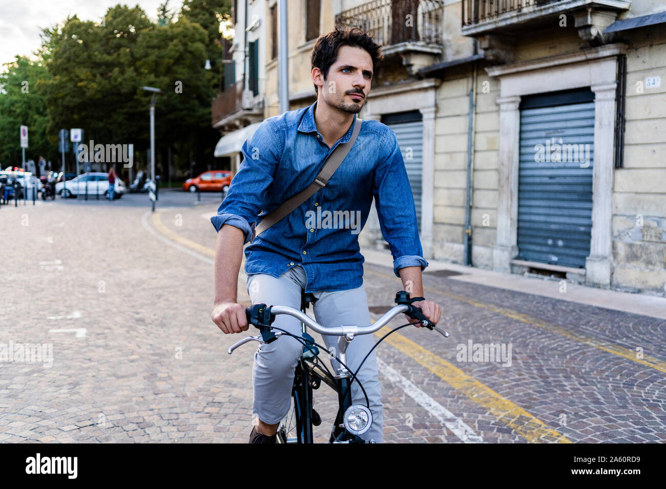 Man riding bicycle in the city Stock Photo - Alamy