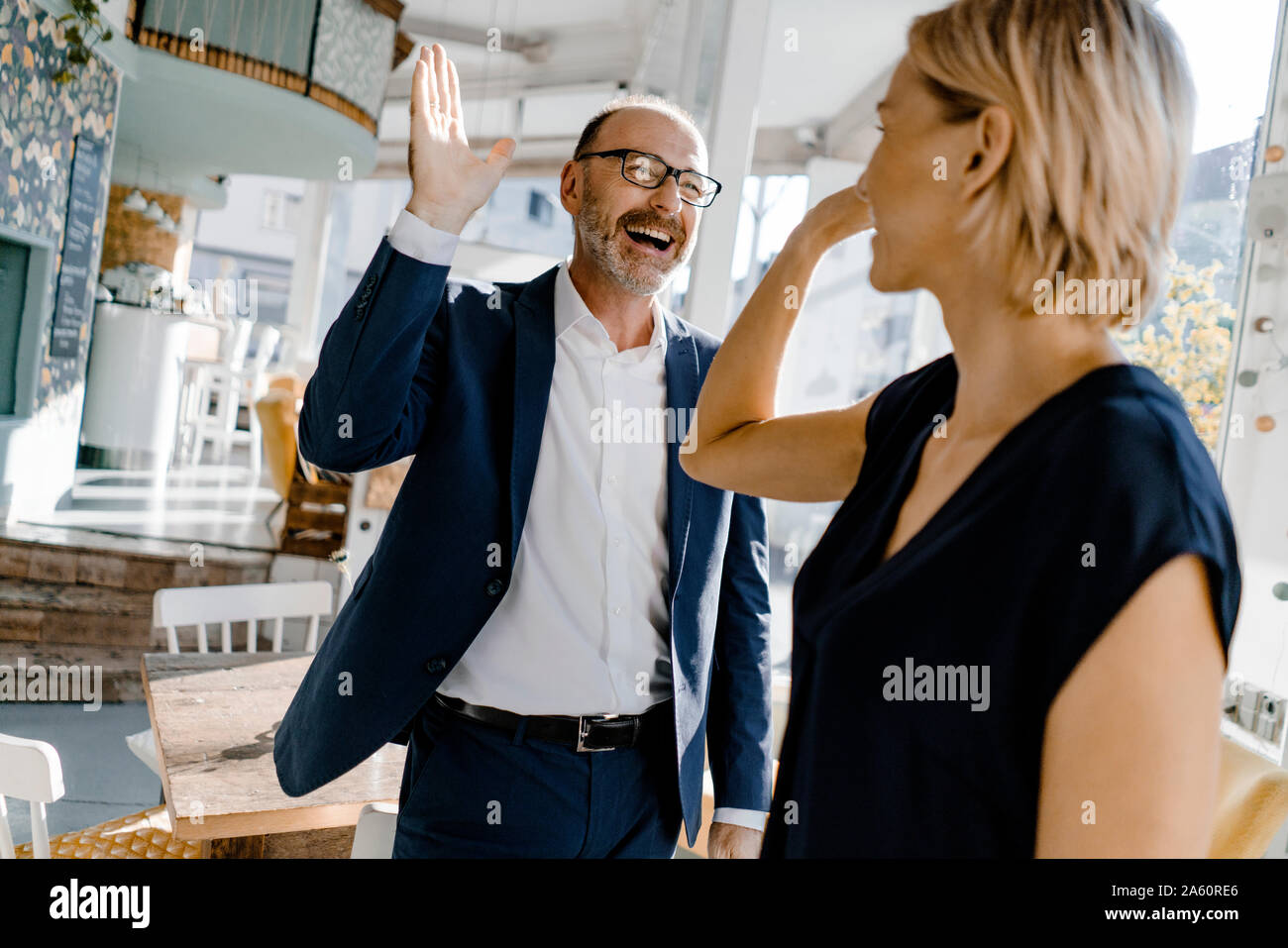 Business people high fiving in hi-res stock photography and images - Alamy